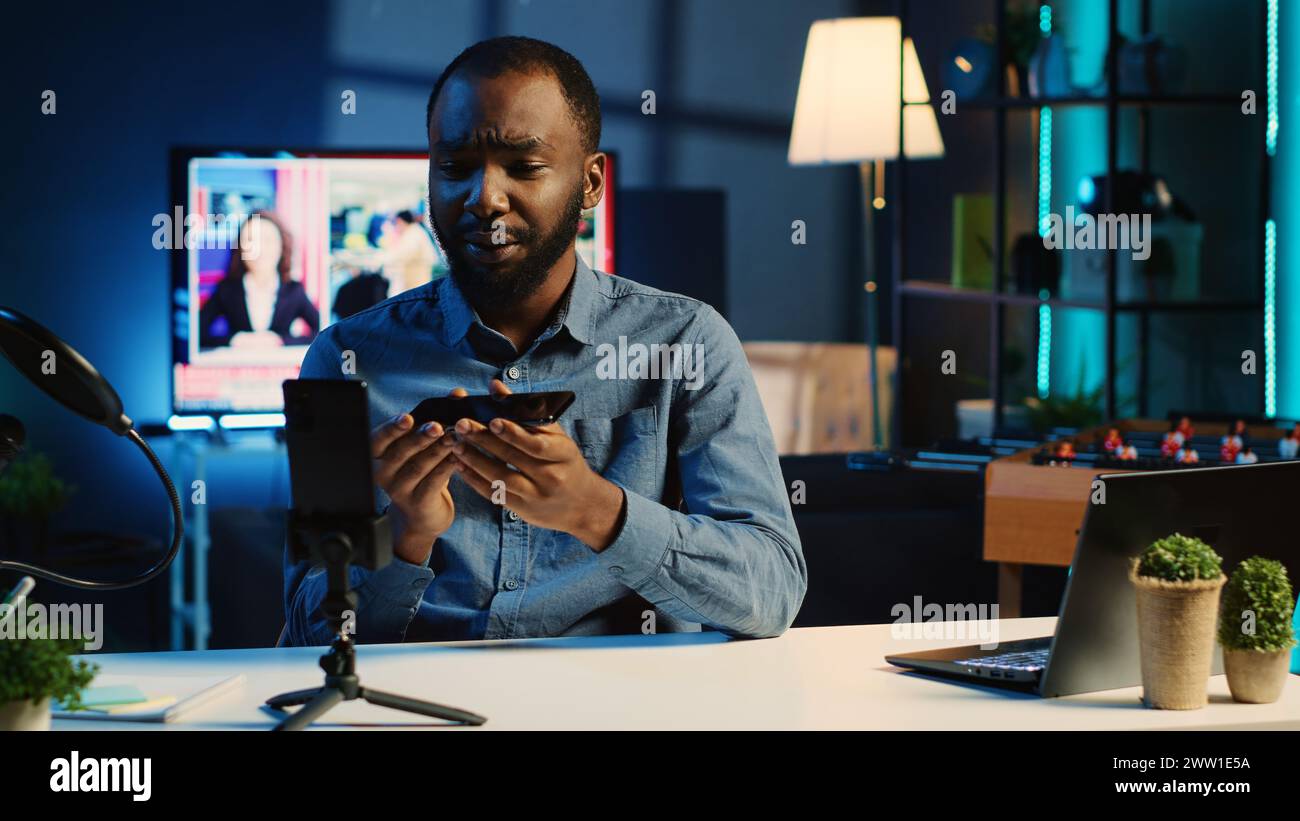 African american technology content creator filming review of newly ...