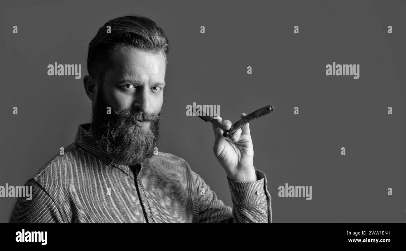 redhead man in barbershop studio. man hold barbershop blade to shave ...