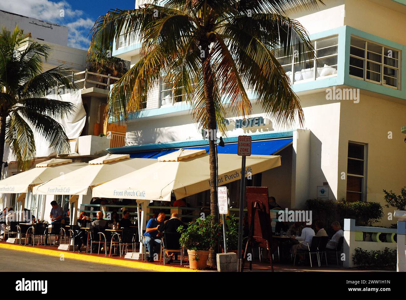 People enjoy an al fresco breakfast under the palm trees at a historic ...