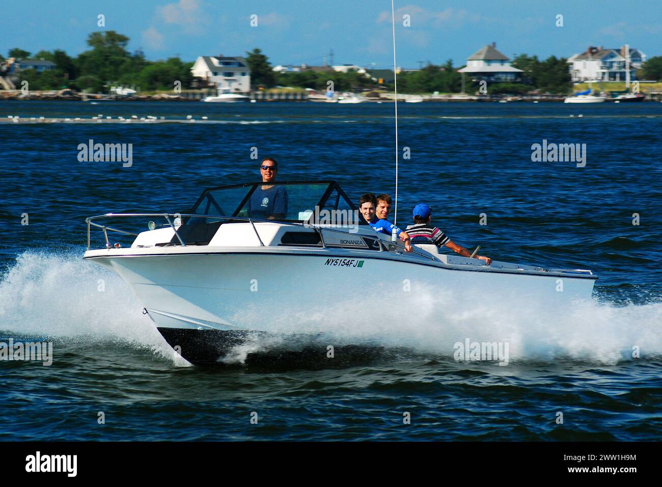 Boy driving boat hi-res stock photography and images - Alamy
