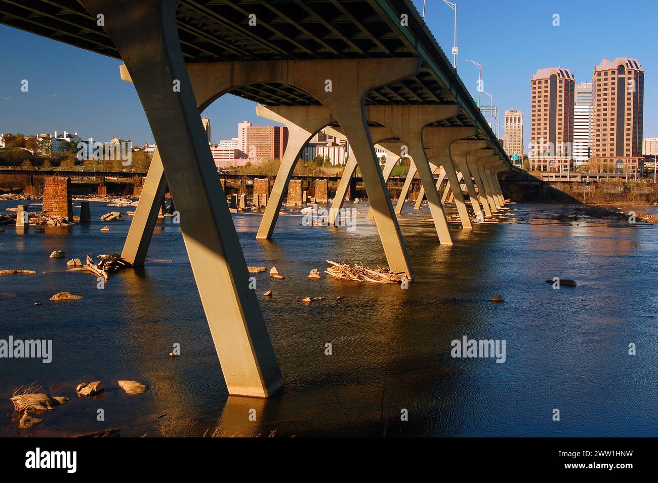 A long interstate highway bridge leads over the James River and heads ...