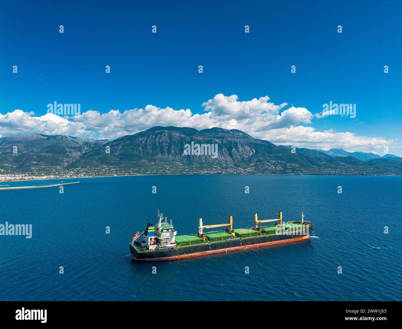 Aerial photo of huge bulk carrier tanker anchored in deep blue Aegean ...