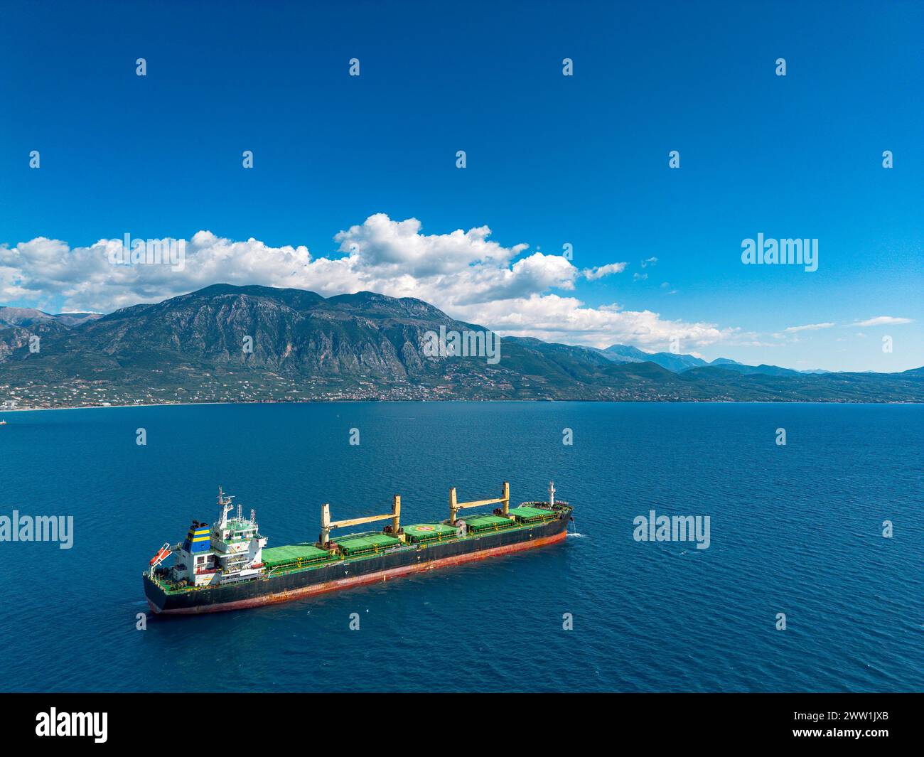 Aerial photo of huge bulk carrier tanker anchored in deep blue Aegean ...