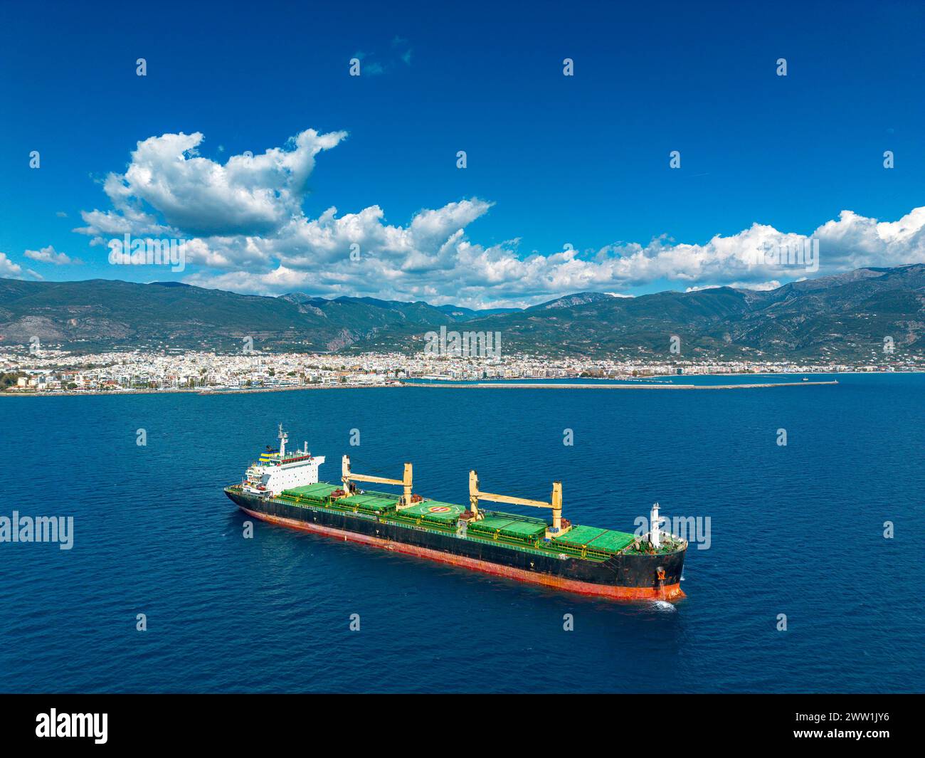 Aerial photo of huge bulk carrier tanker anchored in deep blue Aegean ...
