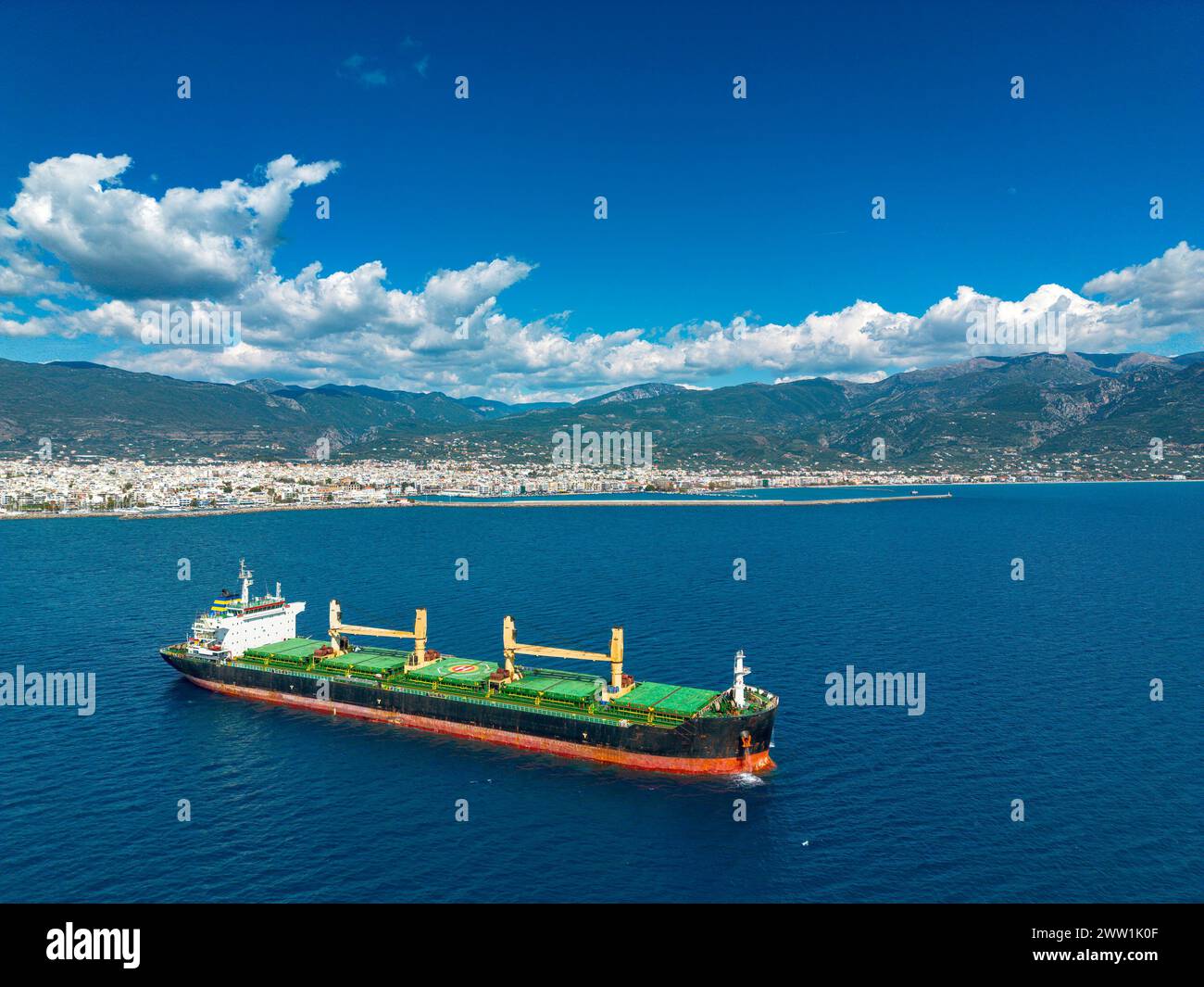 Aerial photo of huge bulk carrier tanker anchored in deep blue Aegean ...