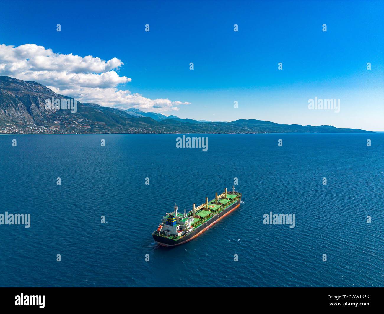Aerial photo of huge bulk carrier tanker anchored in deep blue Aegean ...