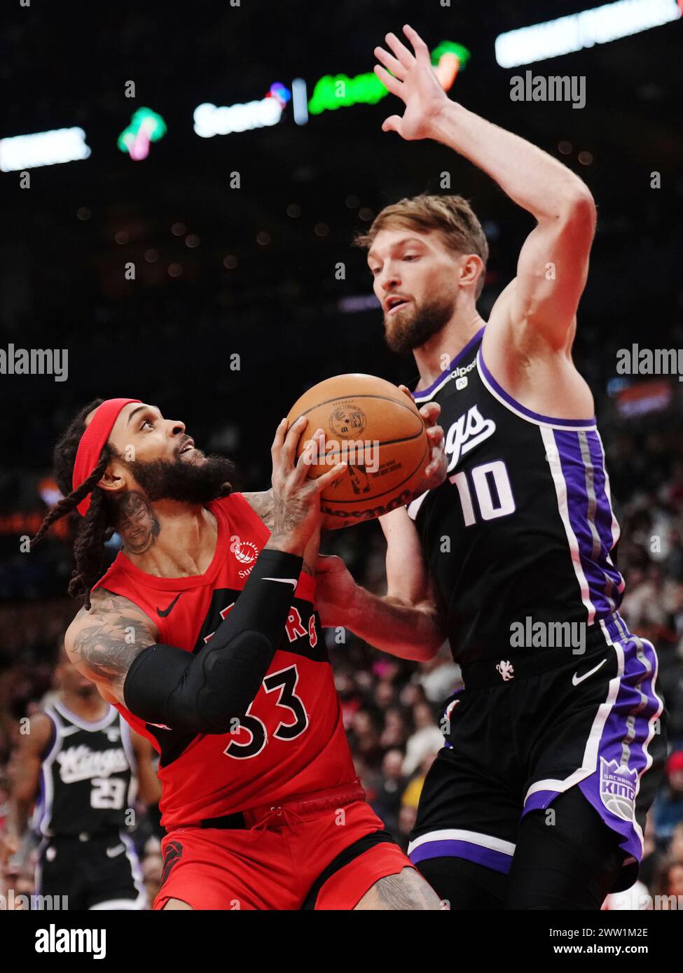 Toronto Raptors guard Gary Trent Jr. (33) looks to shoot past Sacramento Kings forward Domantas ...