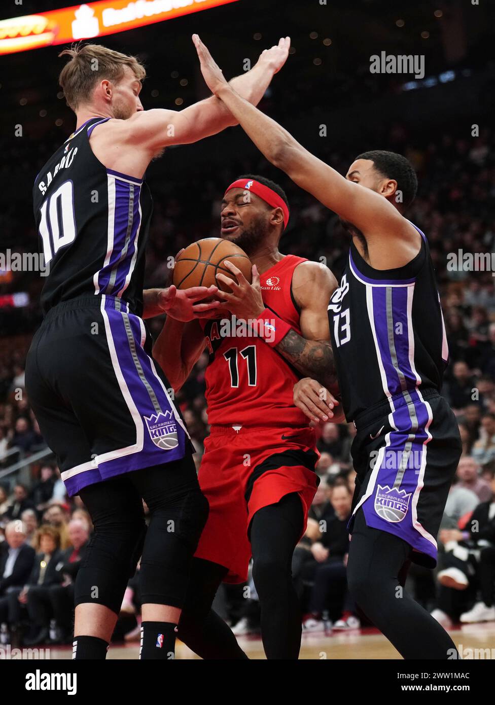 Toronto Raptors forward Bruce Brown (11) can't get past Sacramento Kings forward Domantas ...