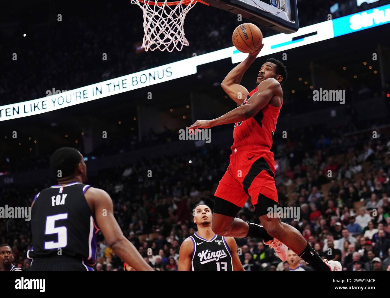 Toronto Raptors guard Ochai Agbaji (30) dunks as Sacramento Kings guard ...