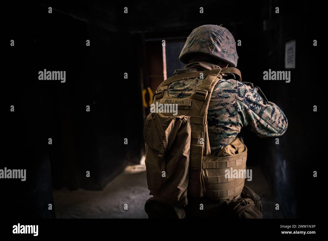 U.S. Marine Corps Lance Cpl. Matthew Pullman executes a close-quarters ...