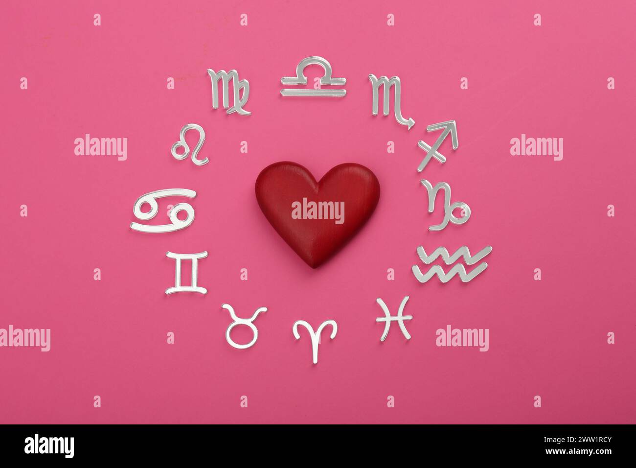 Zodiac signs and red heart on pink background, flat lay Stock Photo - Alamy