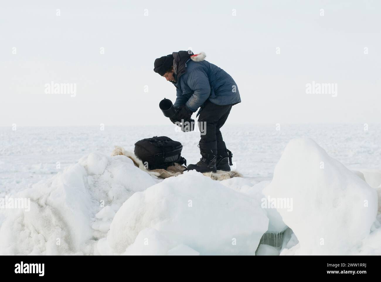 Photographer Steven Kazlowski with camera, tripod at the edge of an ...