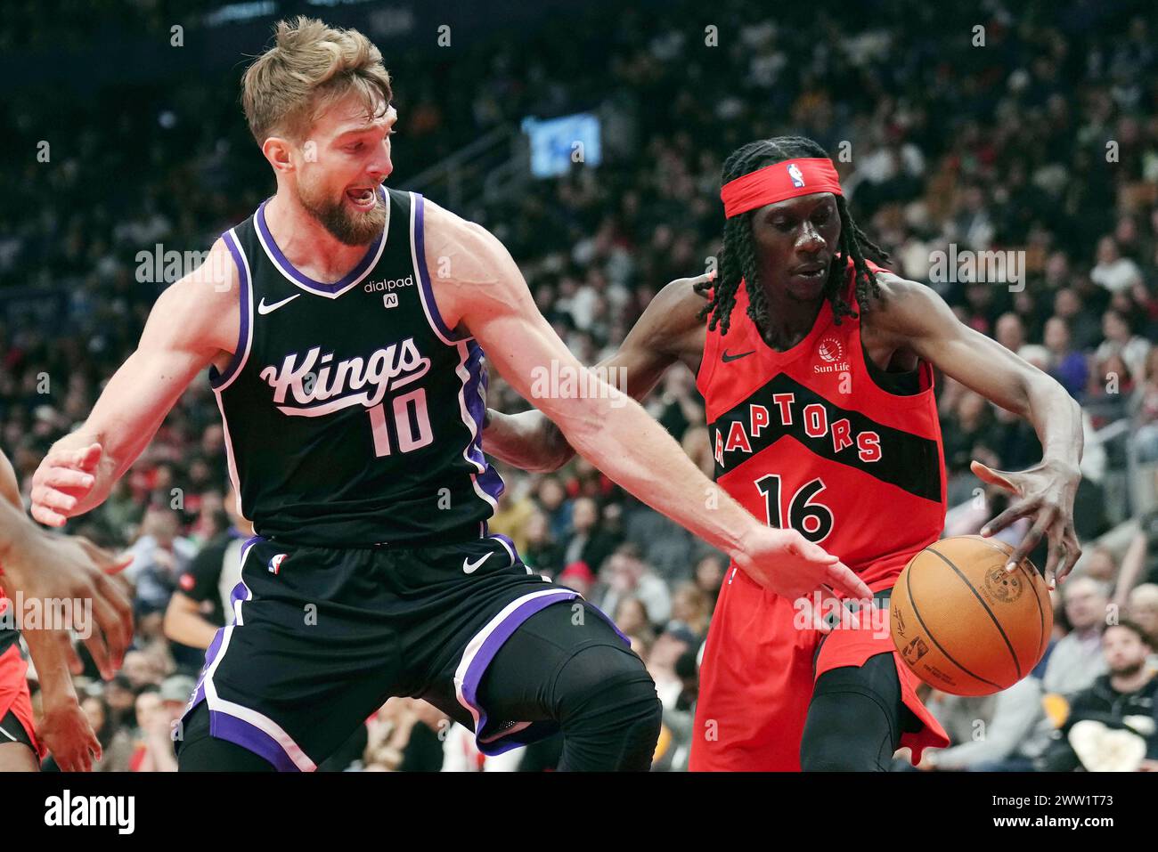 Sacramento Kings forward Domantas Sabonis (10) and Toronto Raptors forward Mouhamadou Gueye (16 ...