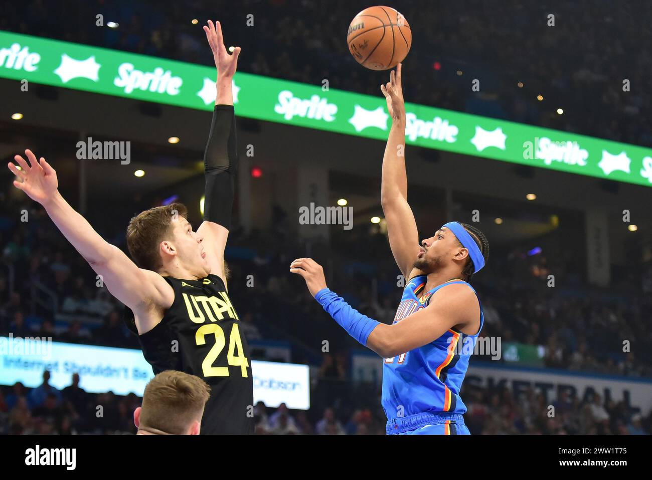 Oklahoma City Thunder guard Aaron Wiggins, right, shoots over Utah Jazz ...