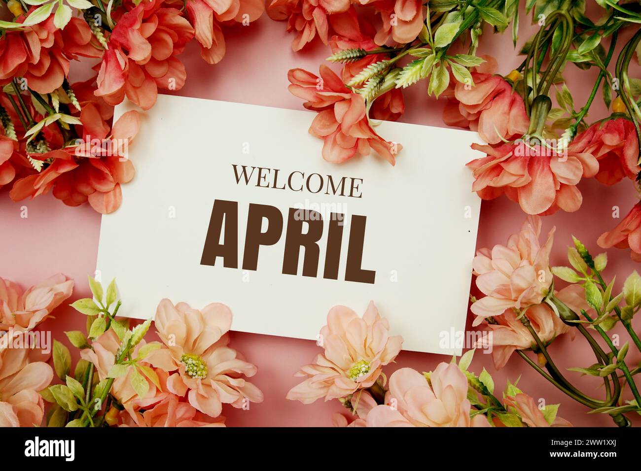 Welcome April typography text with flowers frame on pink background ...
