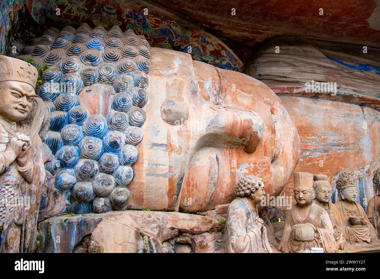 Giant sculpture of Buddha in Nirvana with statues of disciples or ...