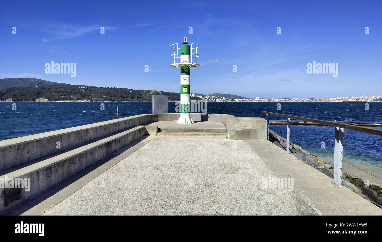 Navigation light post on the concrete pier, Troia Peninsula, Portugal ...