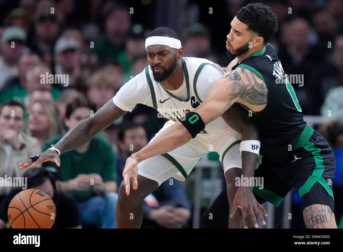 Milwaukee Bucks forward Bobby Portis, left, is defended by Boston Celtics forward Jayson Tatum ...