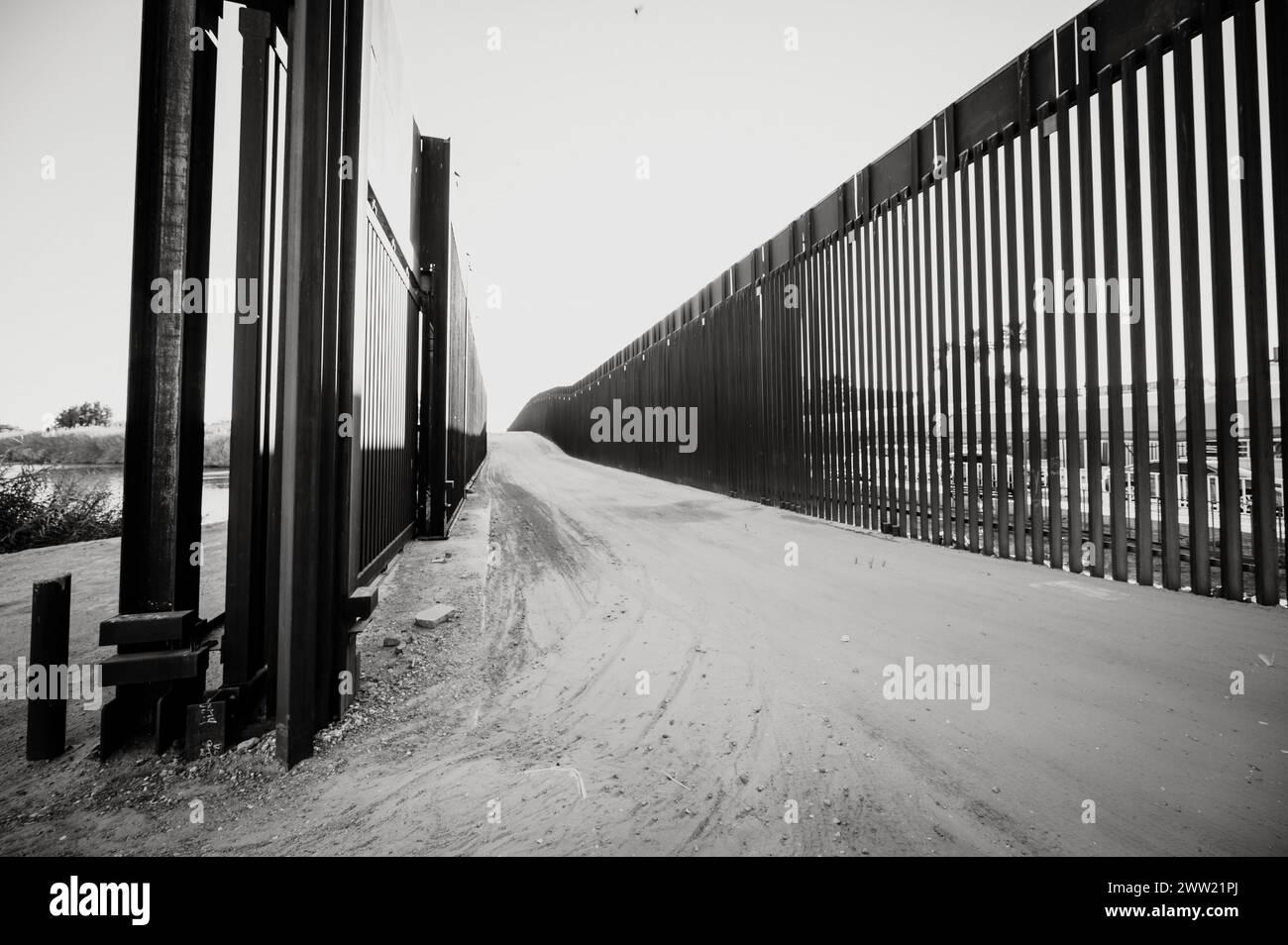 The US border wall between Yuma Arizona and Los Algodones Mexico. Black ...