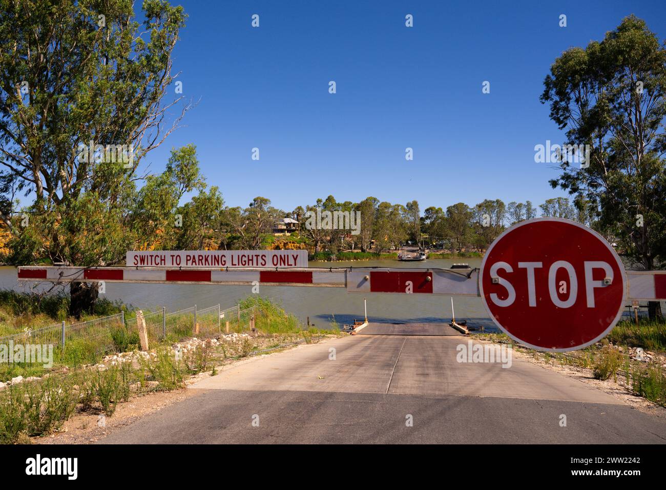 A bold stop sign foregrounding a ferry dock with 'Parking Lights Only ...