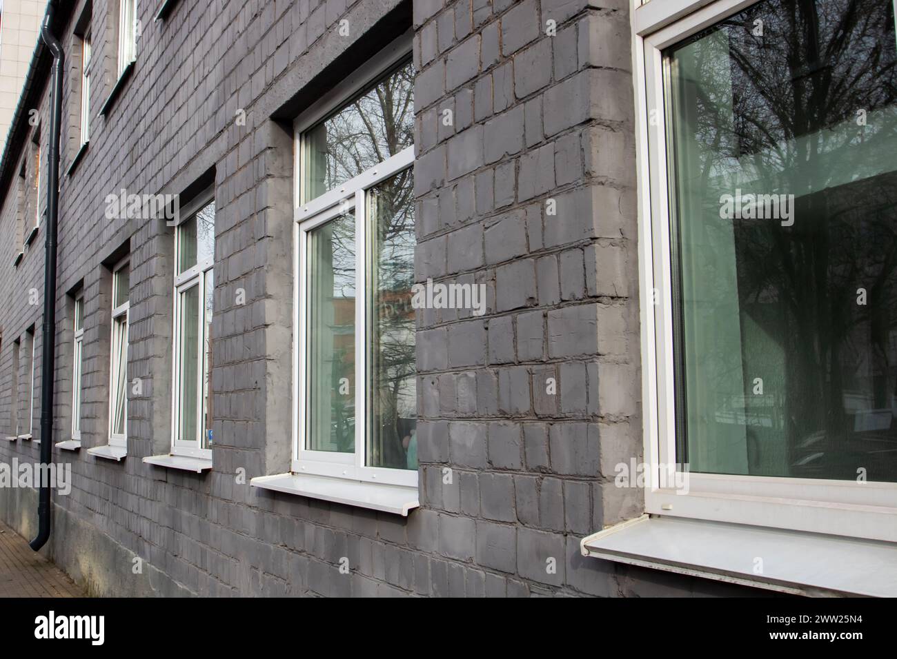 Windows on a modern two-storey building close up Stock Photo - Alamy