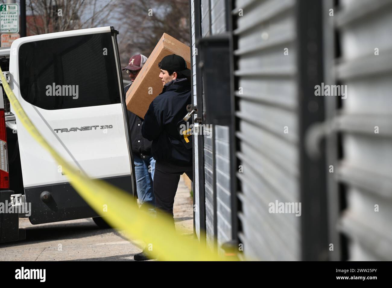 FBI agents load boxes of evidence collected from a warehouse into a ...