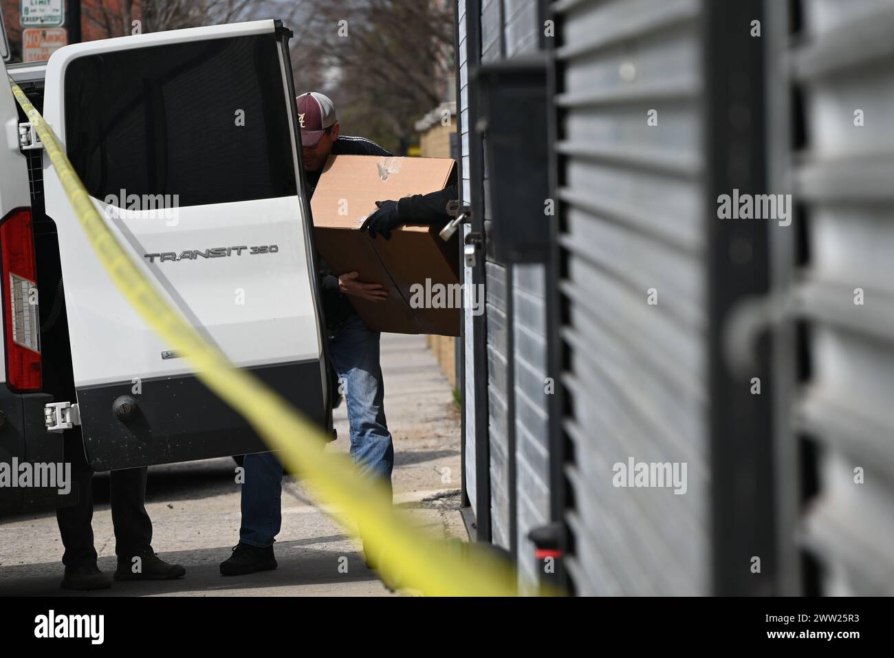 FBI agents load boxes of evidence collected from a warehouse into a ...