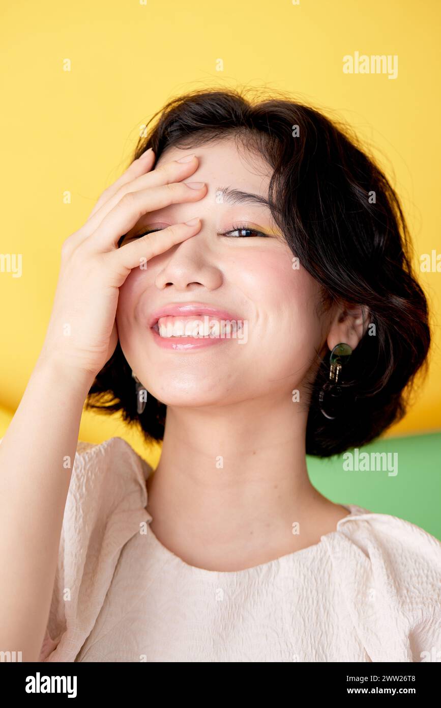 A woman covering her eyes with her hand Stock Photo - Alamy