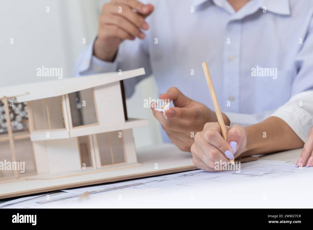 Professional male engineer hand measure house model by using ruler ...