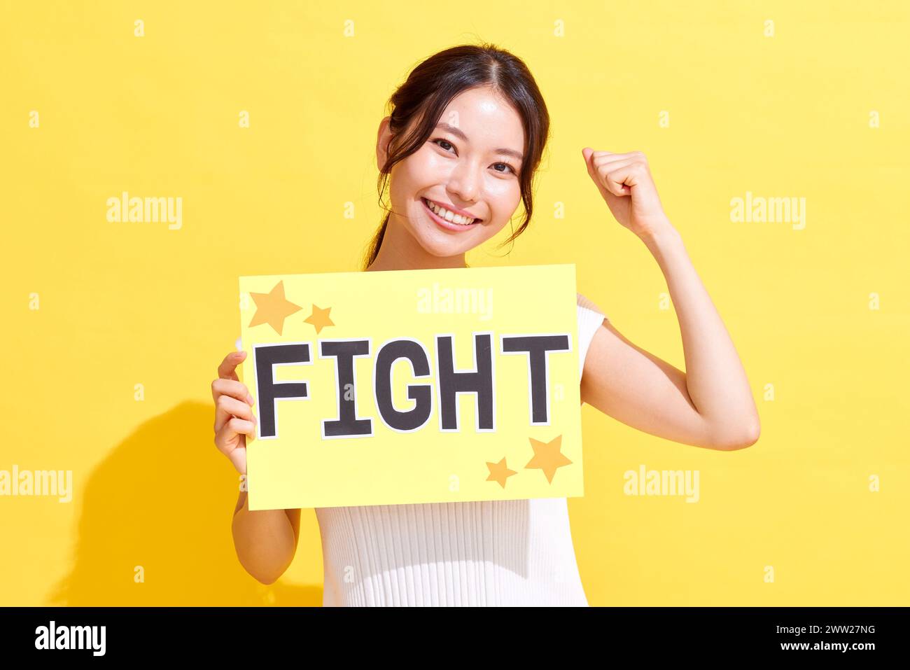Asian woman holding up a fight sign Stock Photo - Alamy