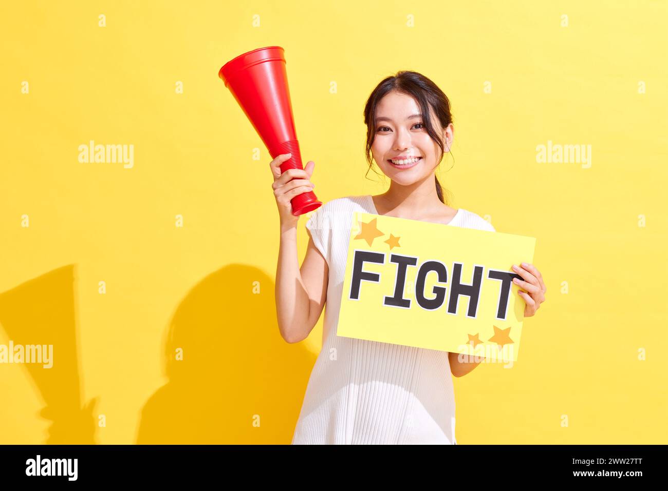 Woman holding up a fight sign with a megaphone Stock Photo - Alamy