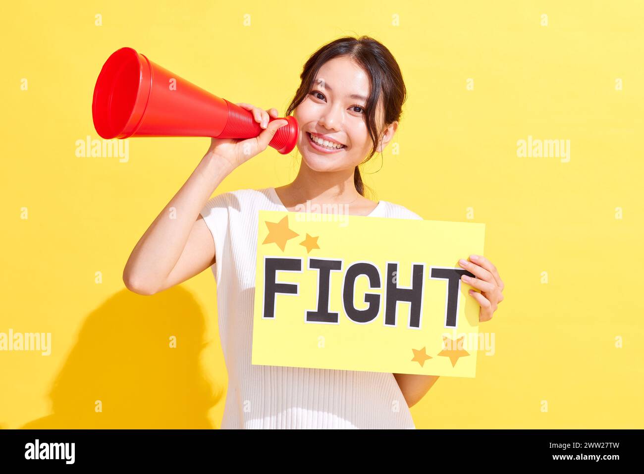 Woman holding up a fight sign with a megaphone Stock Photo - Alamy