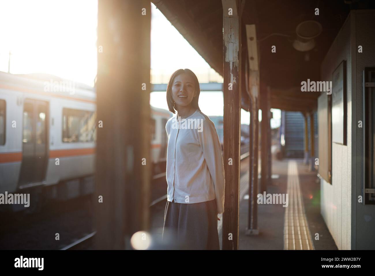Woman smile camera in station hi-res stock photography and images - Alamy