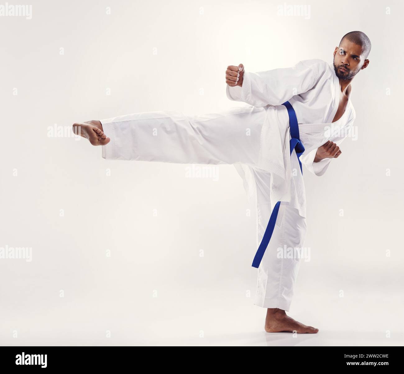Man, kick and karate fighter in studio, fitness and martial arts on ...