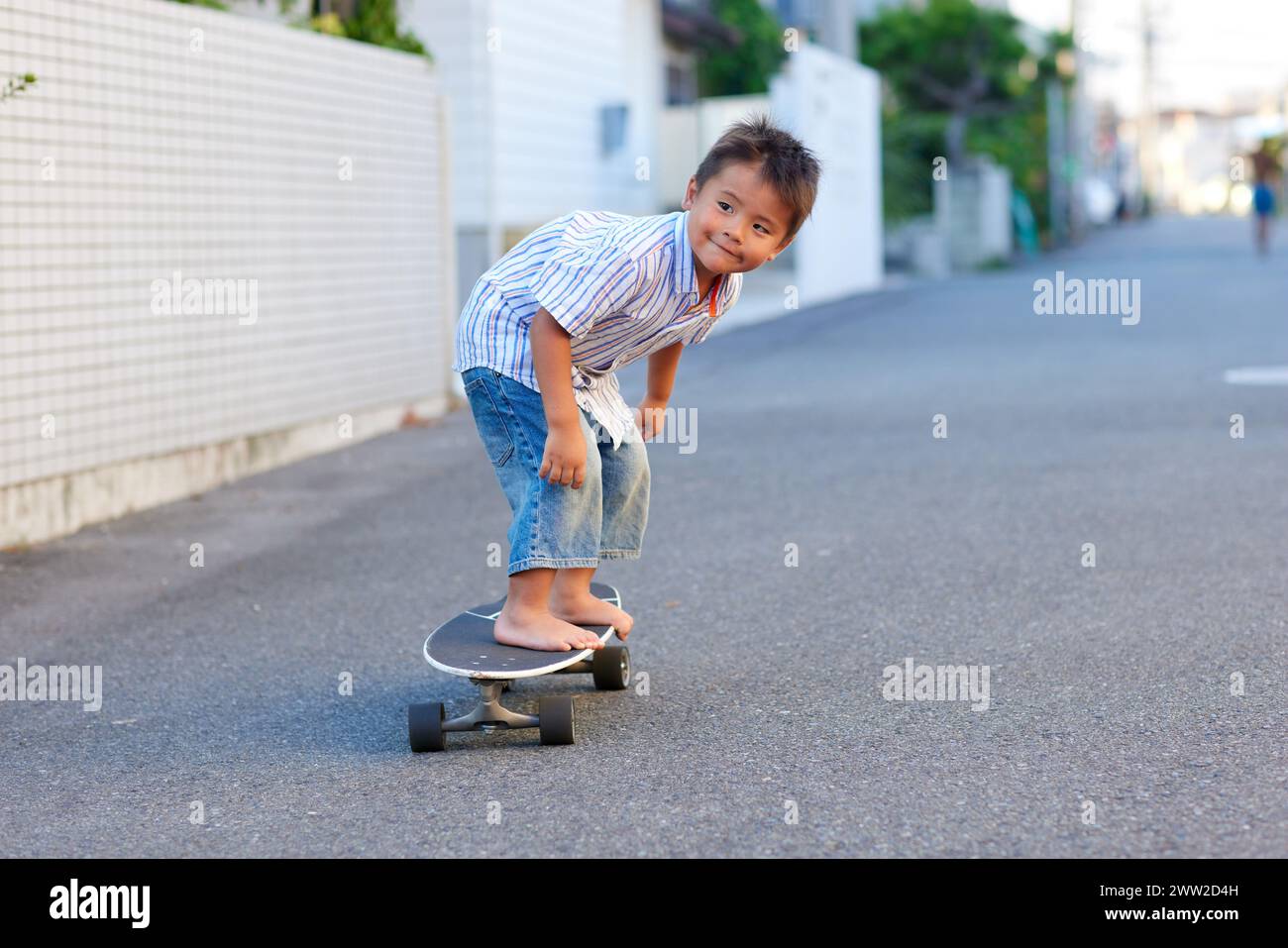 A young boy riding a skateboard Stock Photo - Alamy