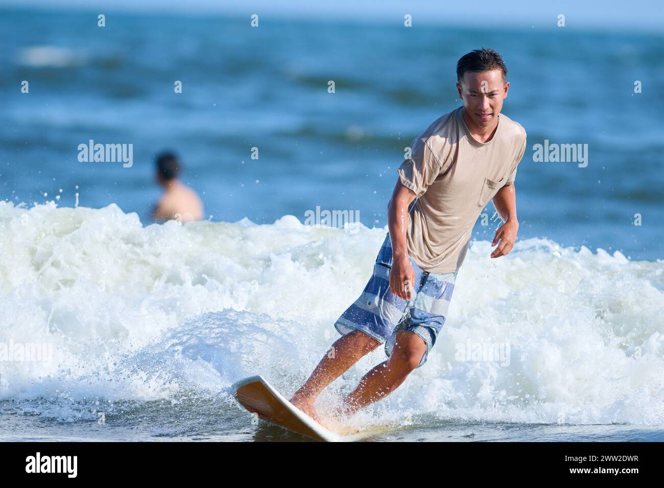 A man riding a surfboard in the ocean Stock Photo - Alamy