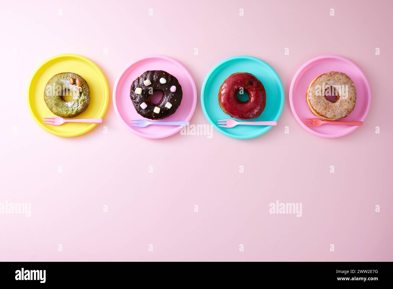 Four colorful plates with donuts on them Stock Photo - Alamy