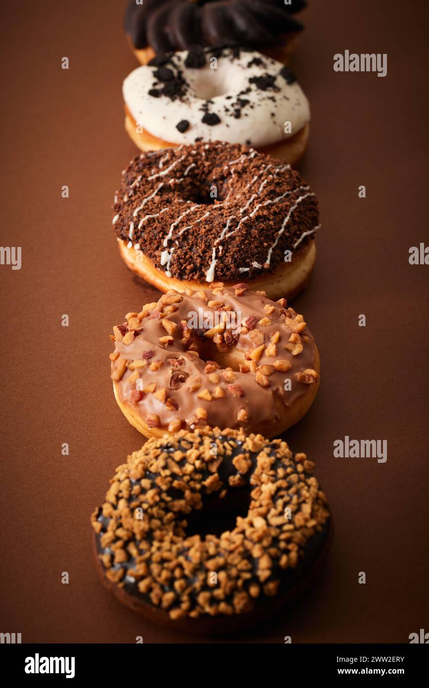 A row of donuts with different toppings Stock Photo - Alamy