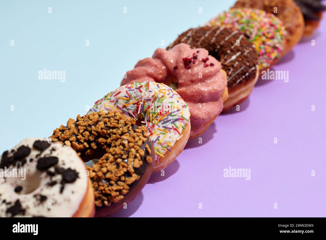 A row of donuts with different toppings Stock Photo - Alamy
