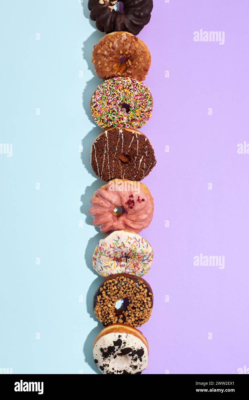 A row of donuts on a purple background Stock Photo - Alamy