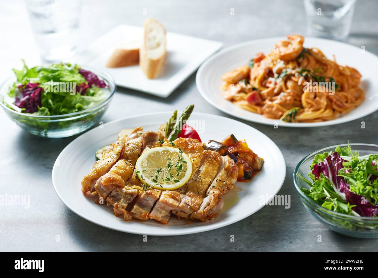 Three plates of food with salad chicken and pasta Stock Photo - Alamy