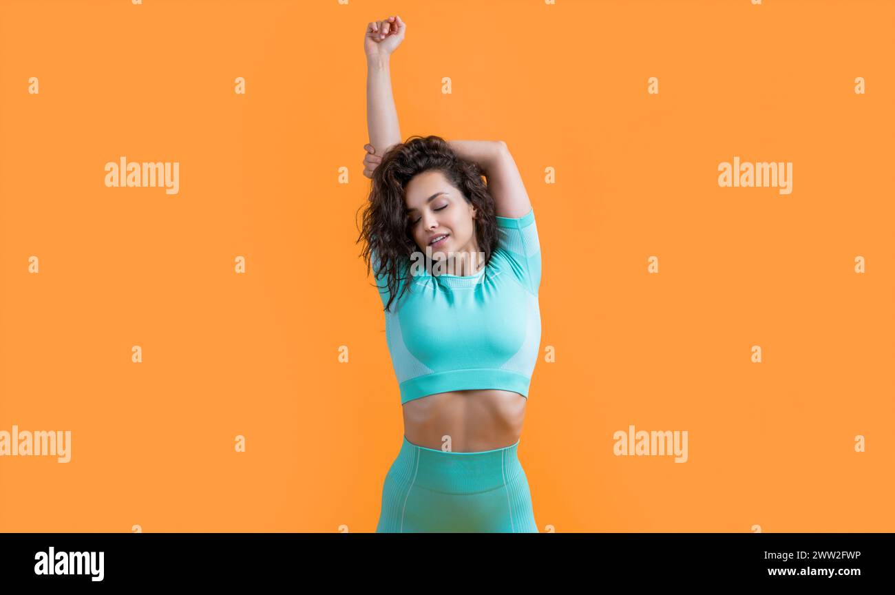 Athletic woman doing overhead arm stretch studio. Fitness and sport ...