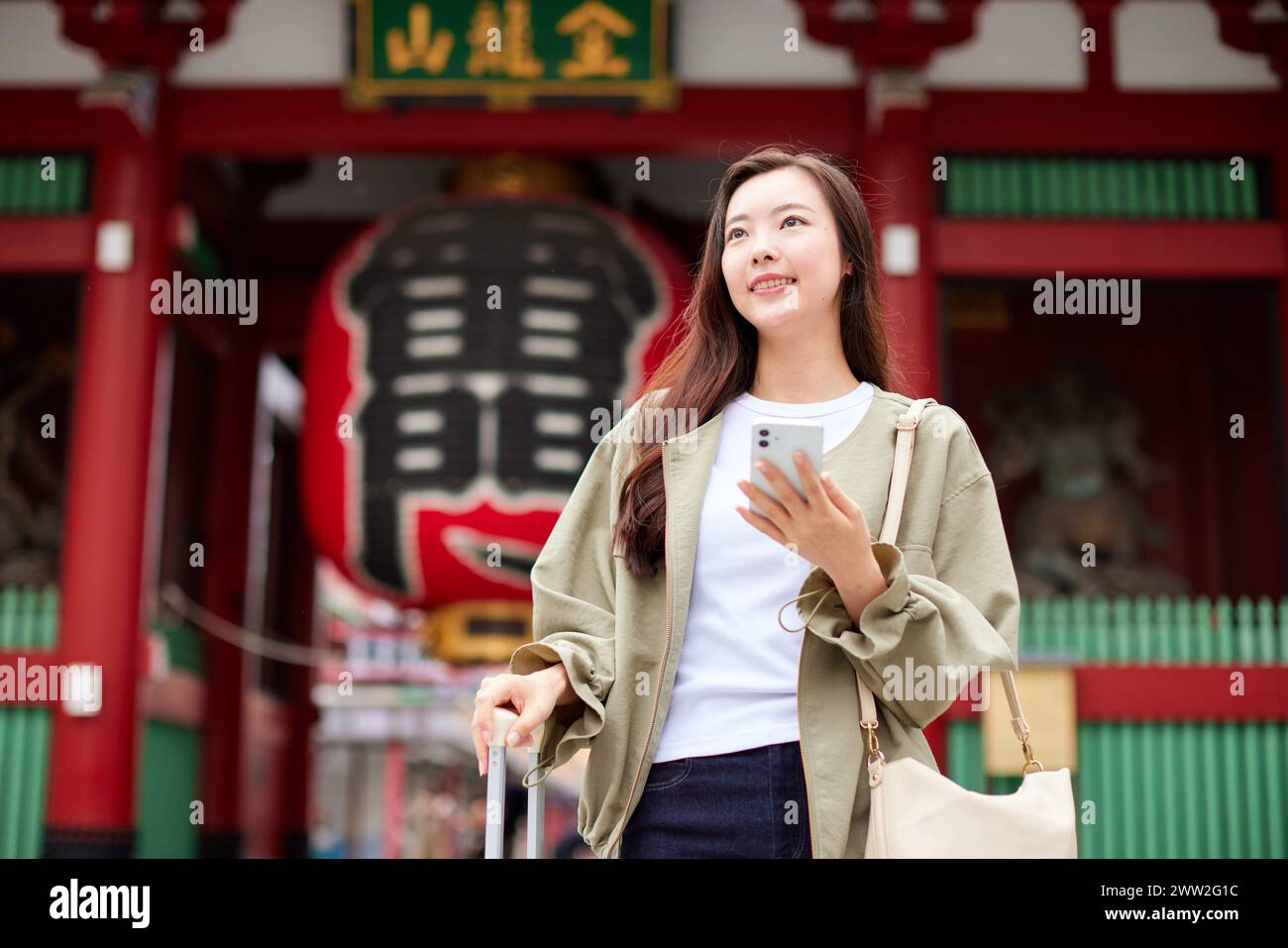A woman standing in front of a temple Stock Photo - Alamy