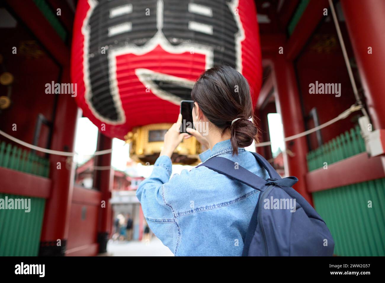 A woman taking a picture of a red lantern Stock Photo - Alamy