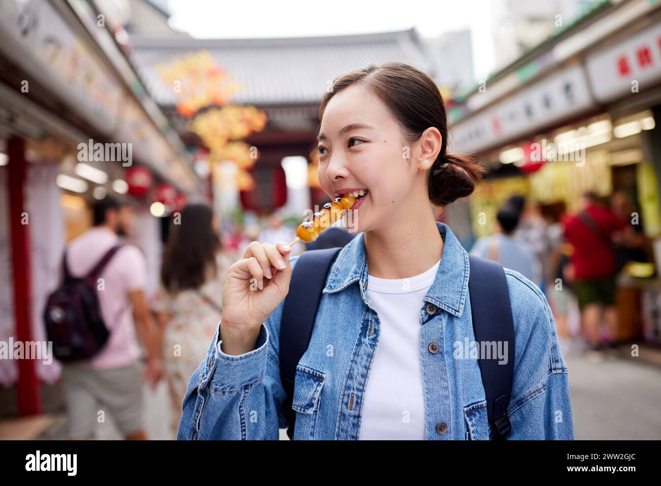 Asian woman eating street food at the temple Stock Photo - Alamy