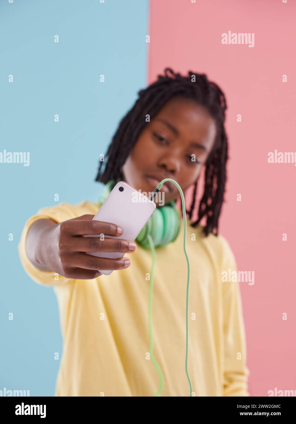 Teen, student and selfie of boy in studio with headphones for listening ...