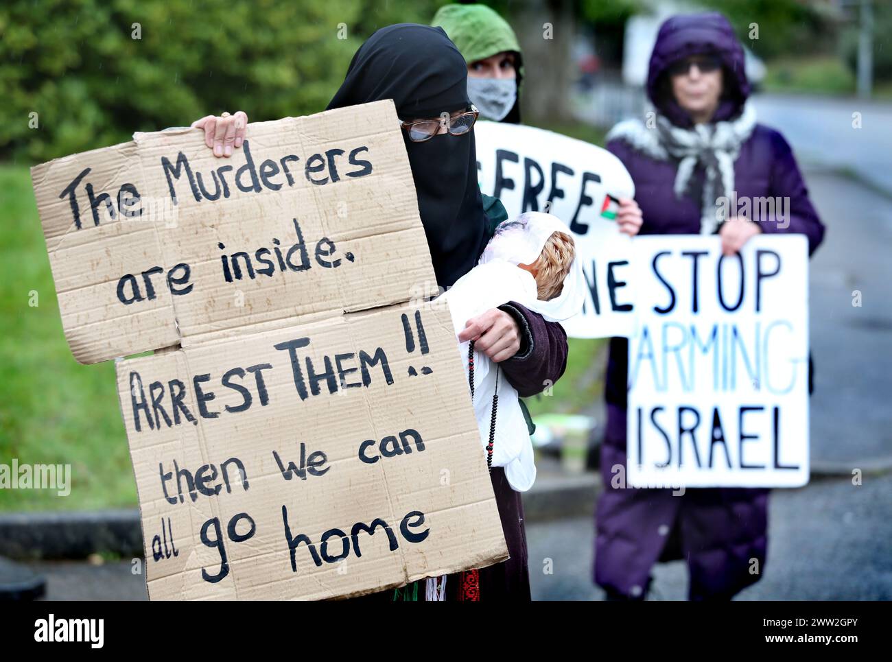 Leicester, UK. 20th Mar, 2024. Protesters hold signs criticising ...