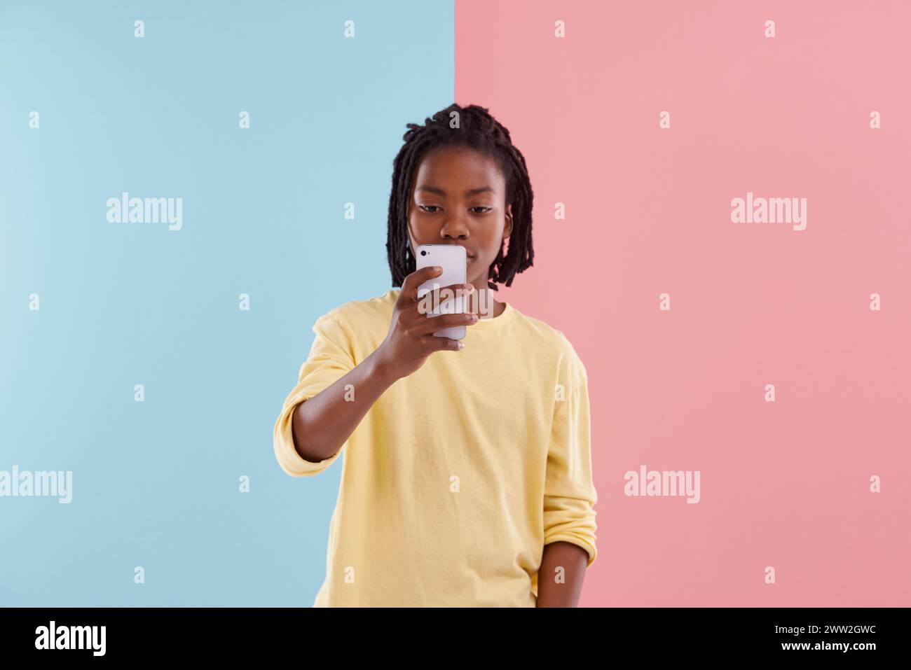 Teen, boy and selfie of student in studio, background with color and ...