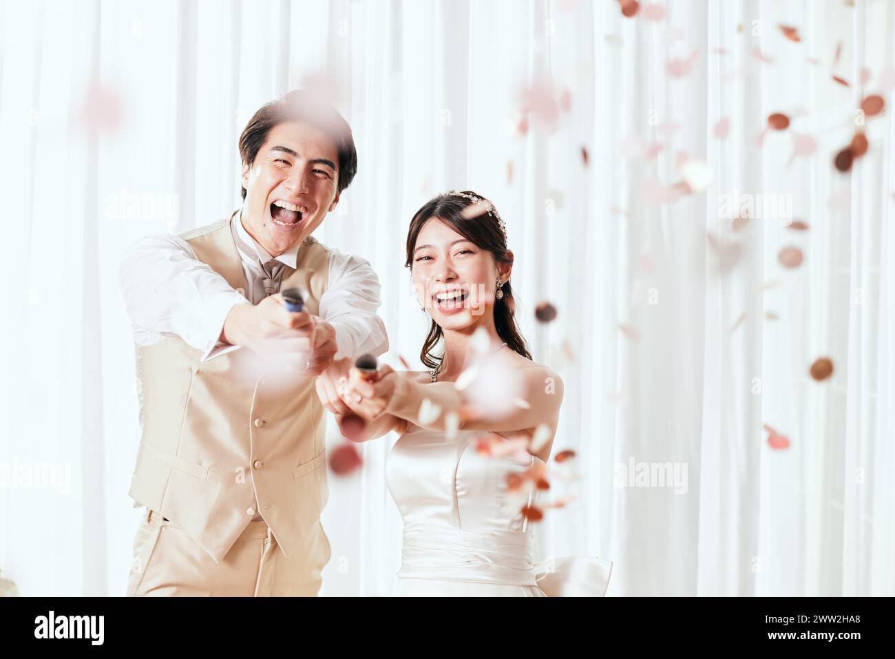 A newly married couple having fun with confetti Stock Photo - Alamy