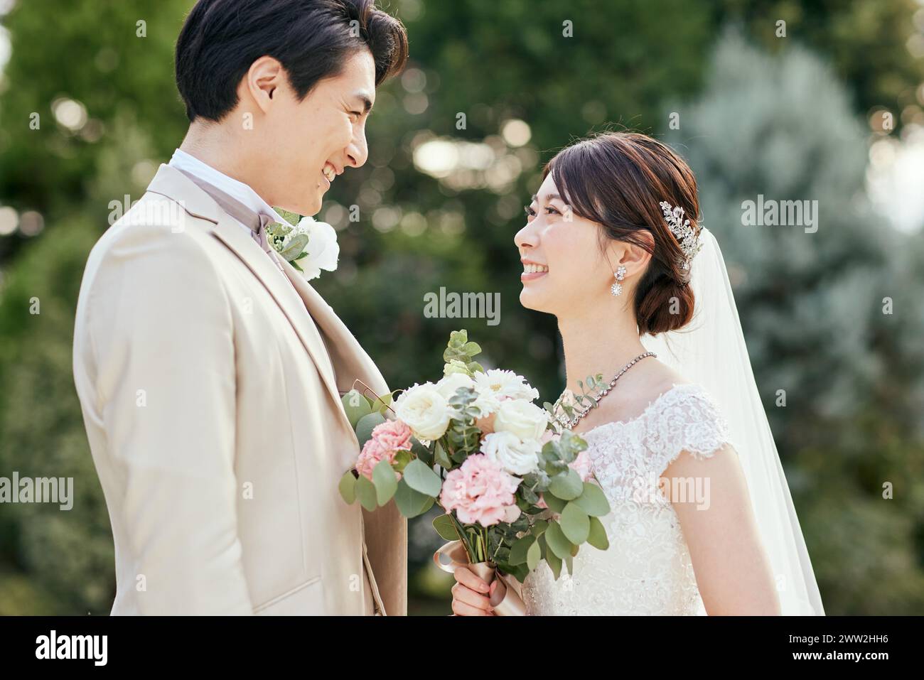 A bride and groom smile at each other Stock Photo - Alamy